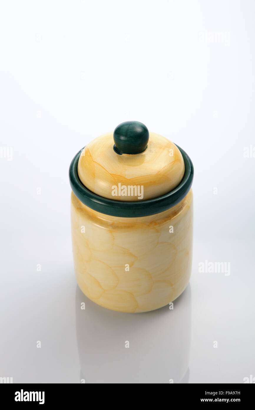 yellow color porcelain jar on the white background Stock Photo - Alamy