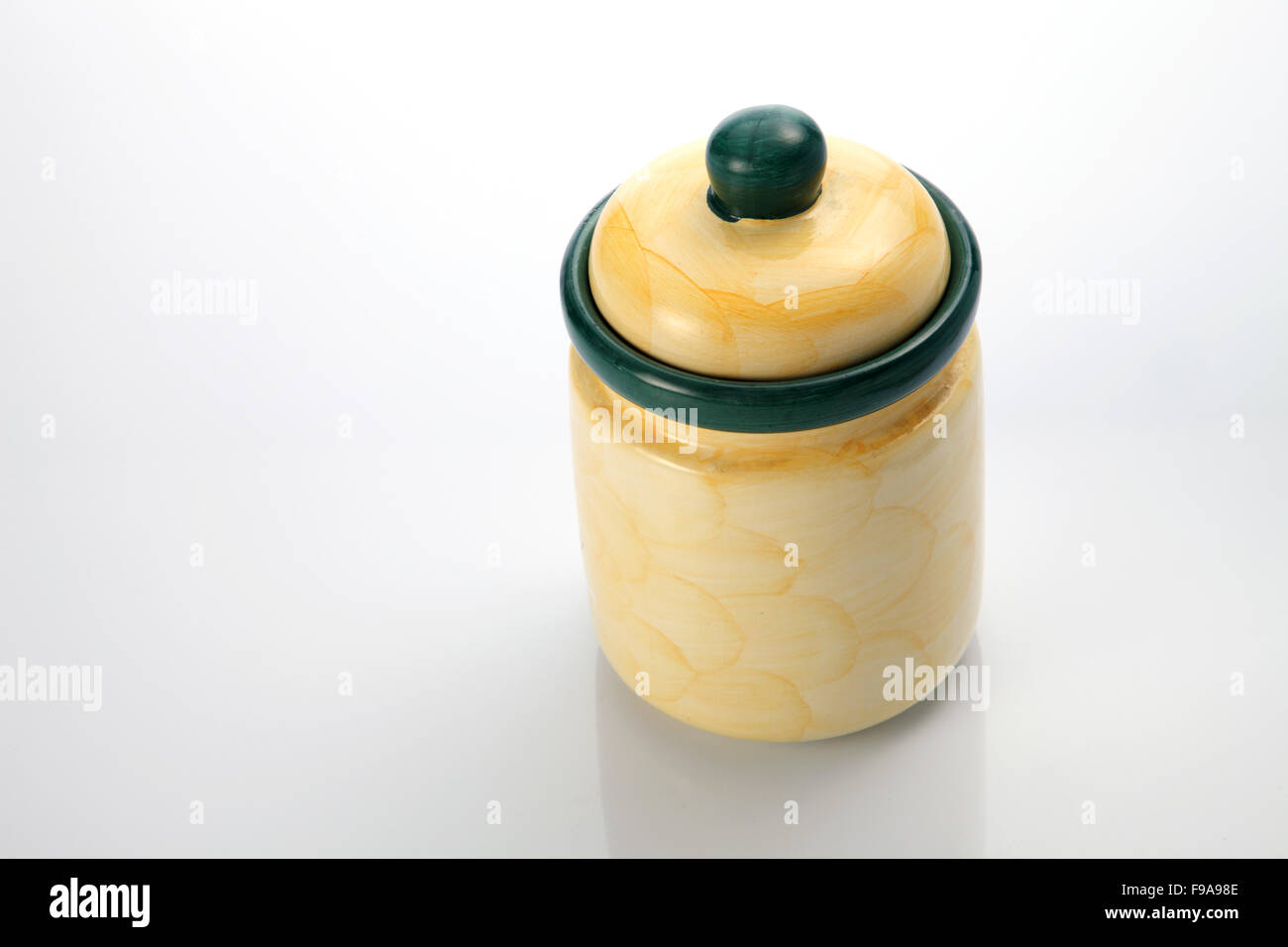 yellow color porcelain jar on the white background Stock Photo - Alamy