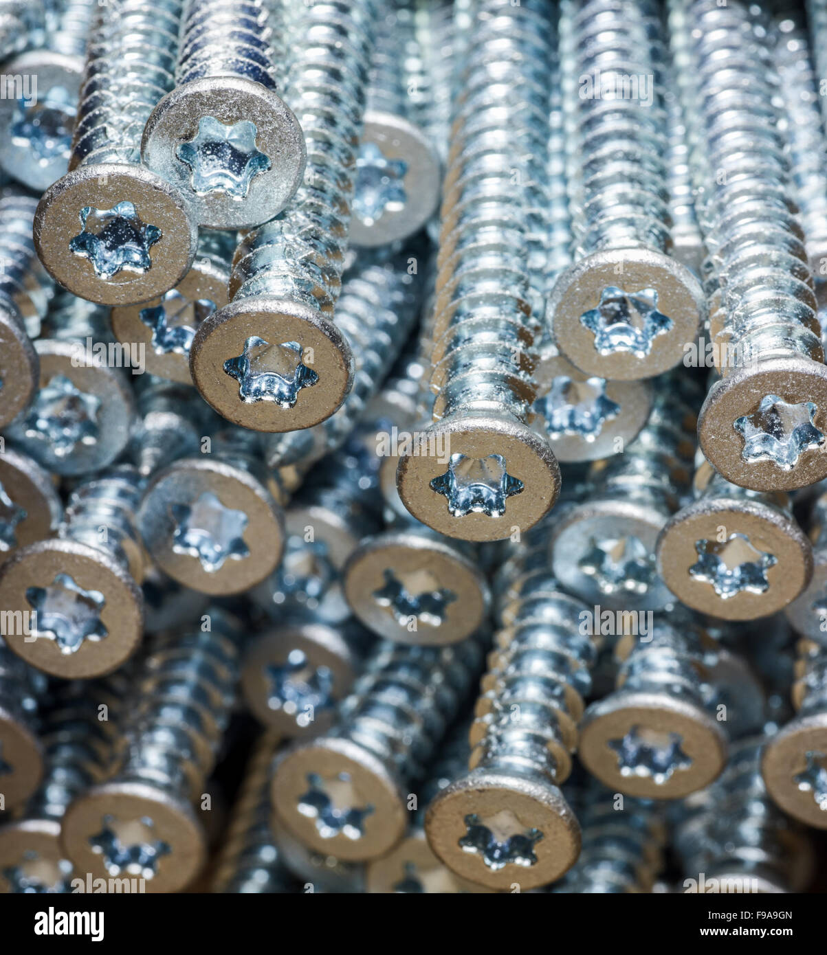 full frame background showing lots of long screws Stock Photo - Alamy