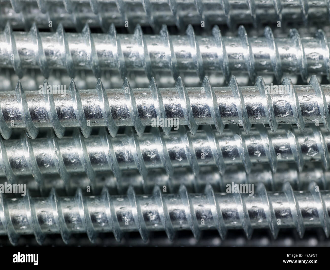 full frame background showing lots of long screws Stock Photo - Alamy