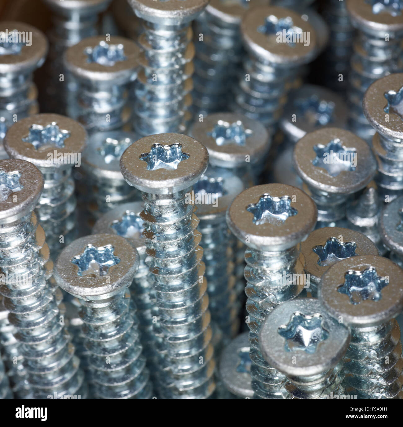 full frame background showing lots of long screws Stock Photo - Alamy