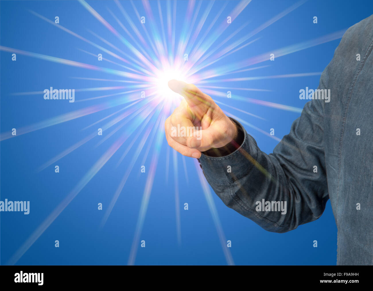 pointing male hand with starlight in blue back Stock Photo - Alamy
