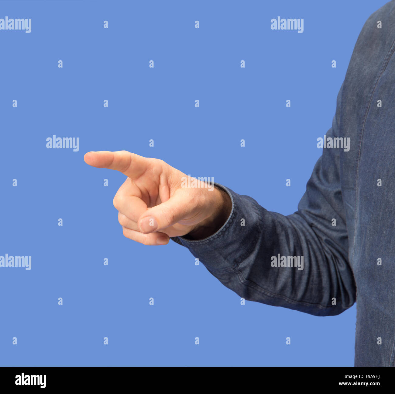 pointing male hand in blue back Stock Photo - Alamy