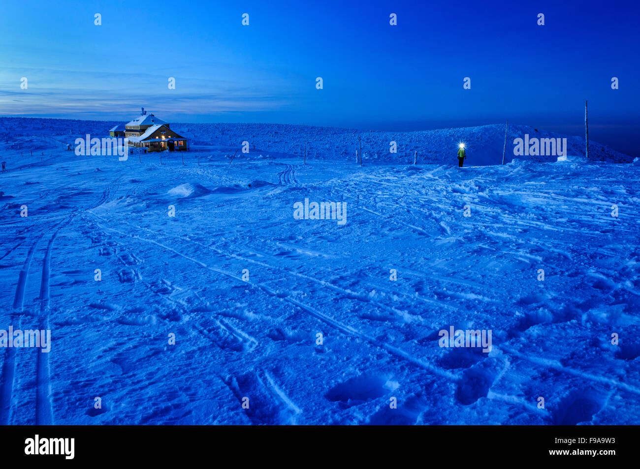 walker in a winter landscape using a headlamp, Mount Sniezka ...