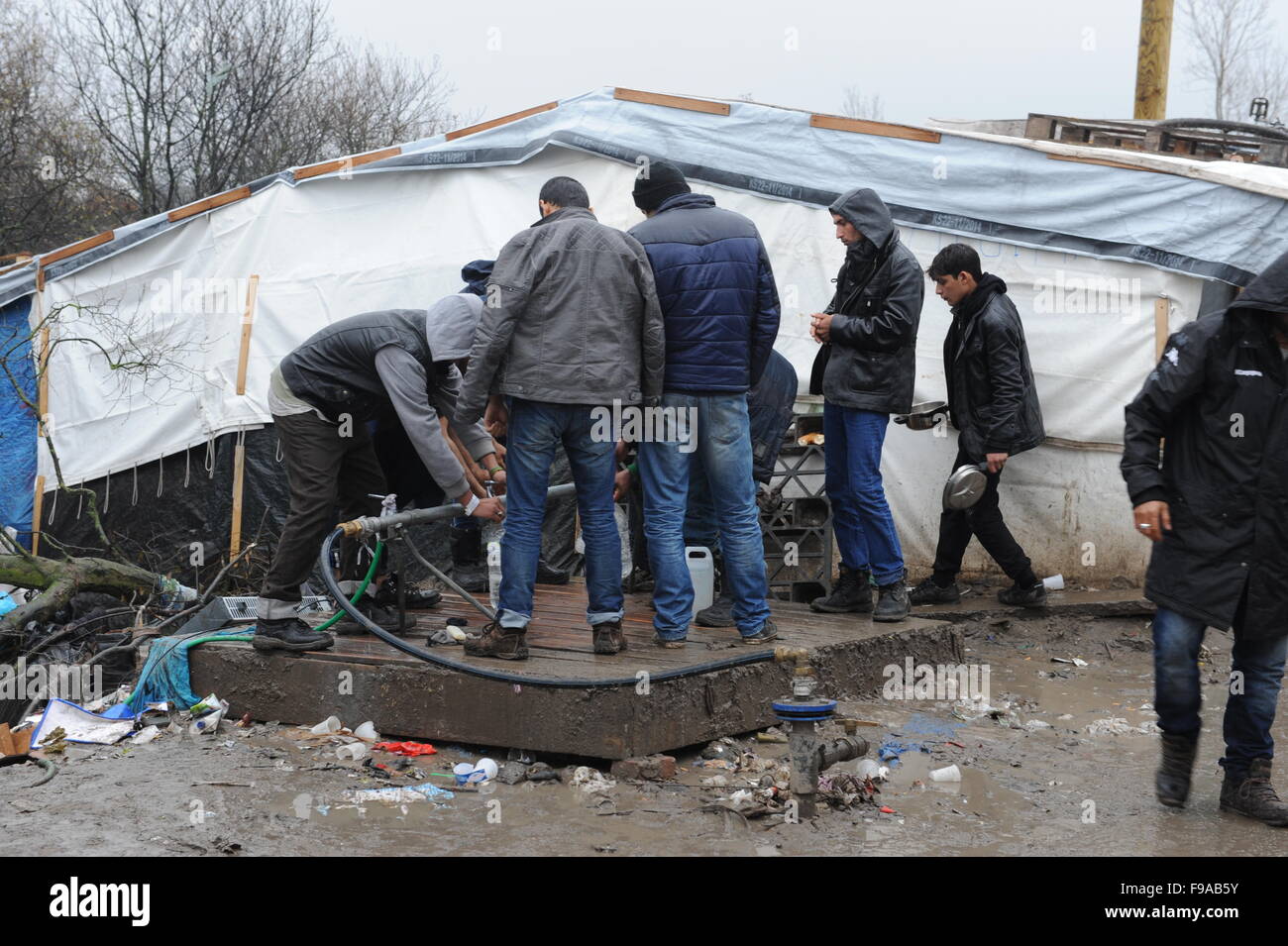 View of half built wooden shelter in the overcrowded, muddy conditions ...