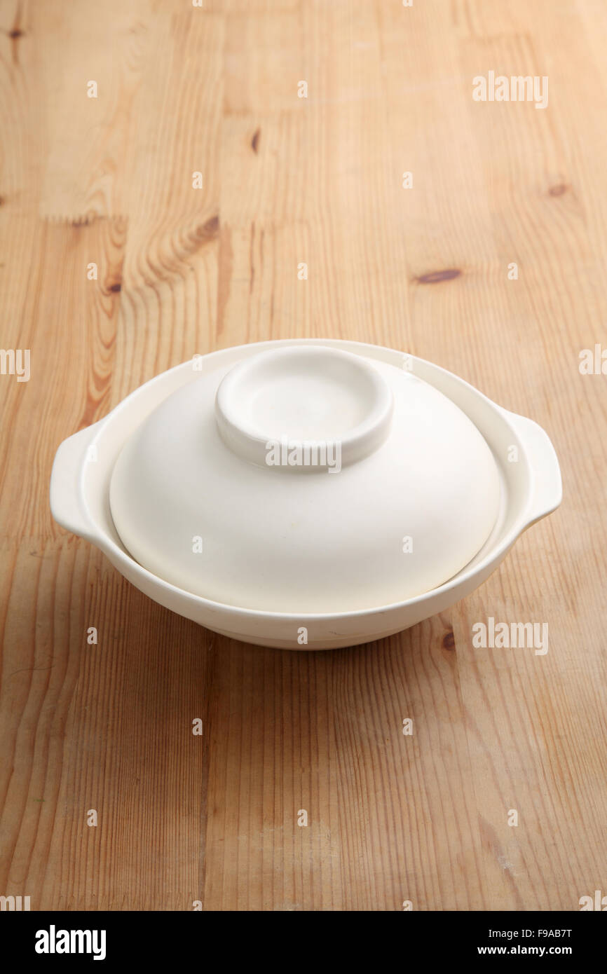 chinese empty clay pot on the wooden background Stock Photo - Alamy