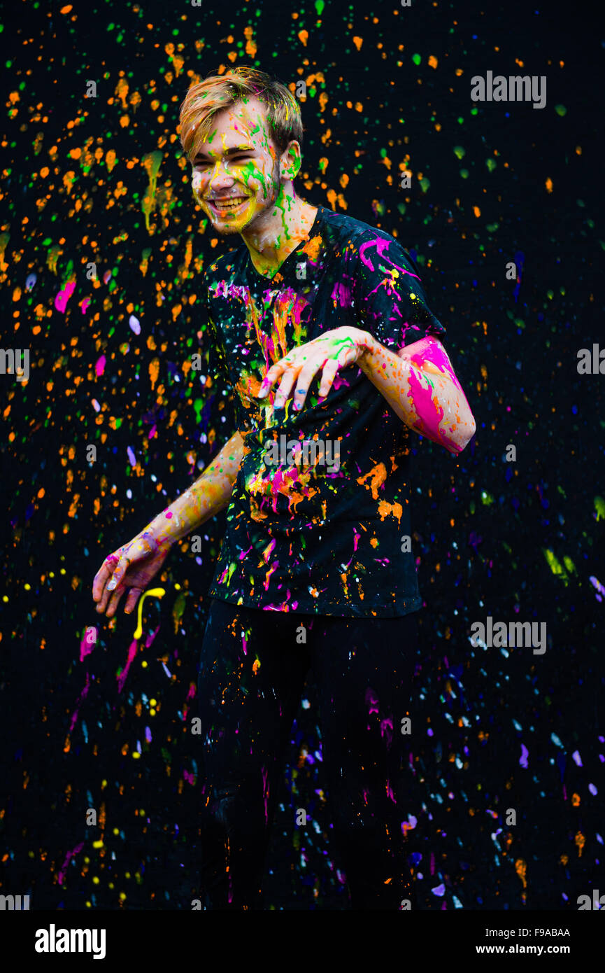A young man male boy model dancer standing dancing against a black ...