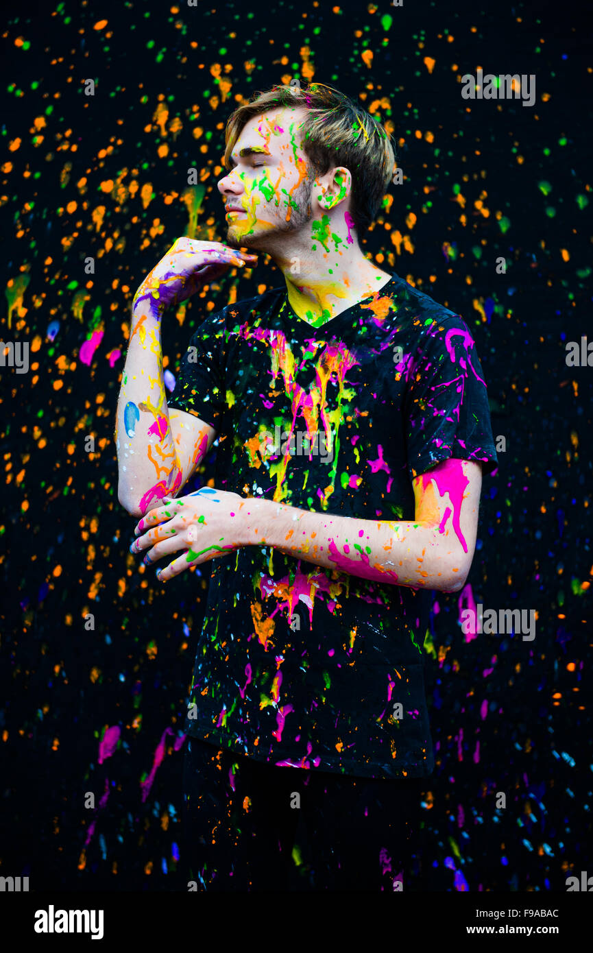 A young man male boy model dancer standing dancing against a black ...