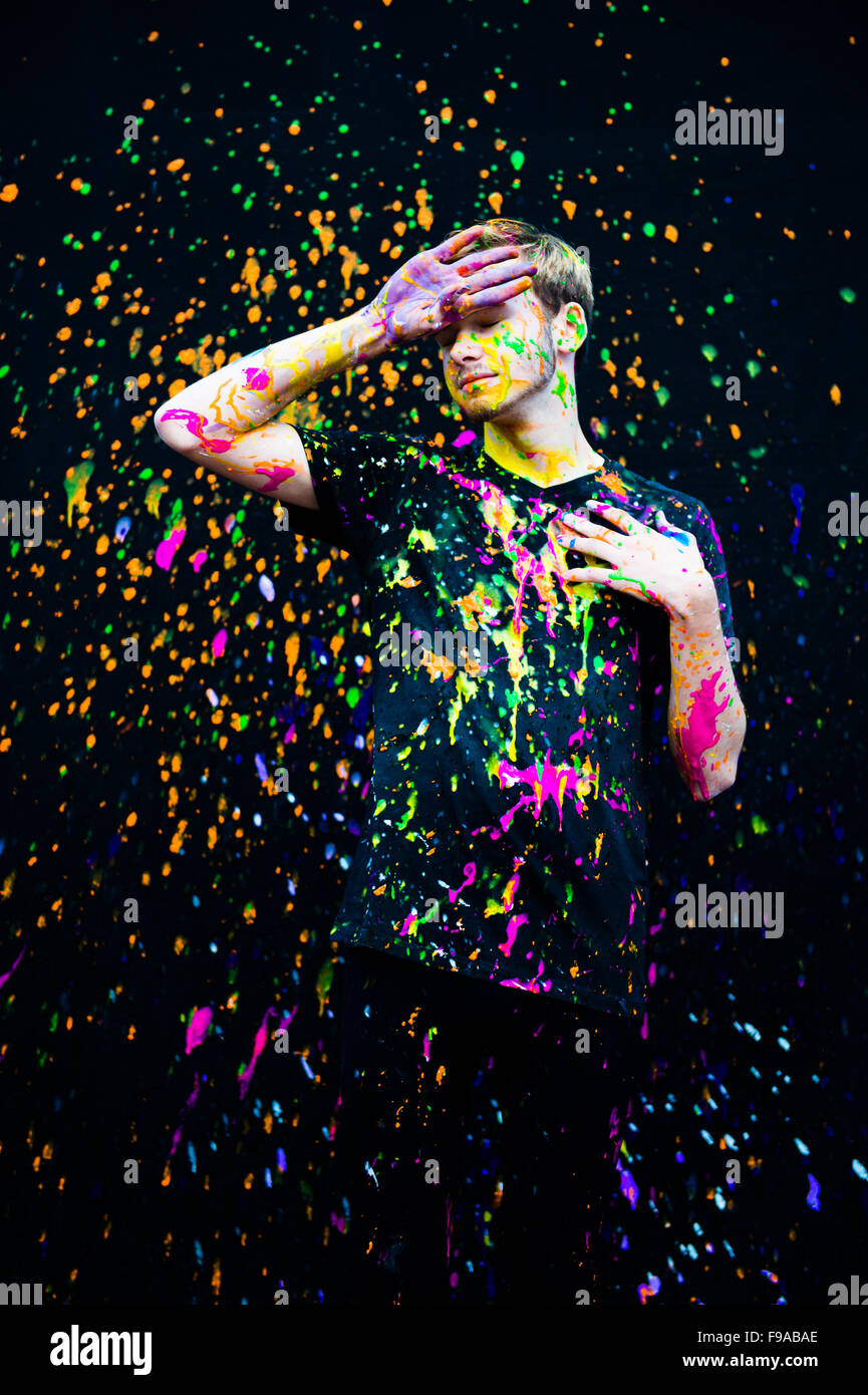 A young man male boy model dancer standing dancing against a black ...