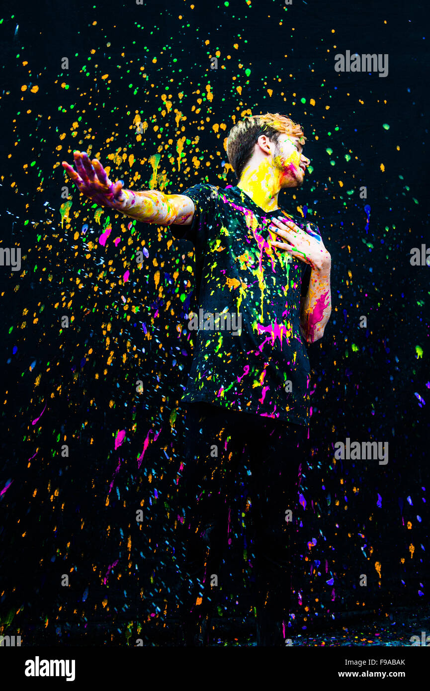 A young man male boy model dancer standing dancing against a black ...