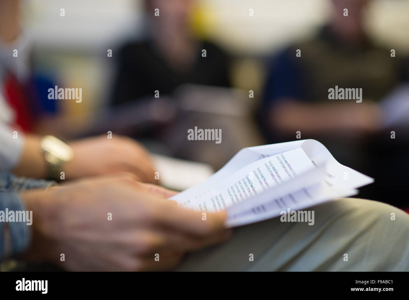 Committee members of a Community Forum holding their agendas and ...
