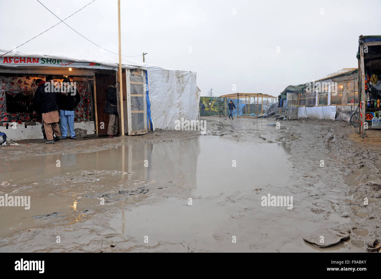 View of makeshift shop and the muddy flooded conditions in the Jungle ...