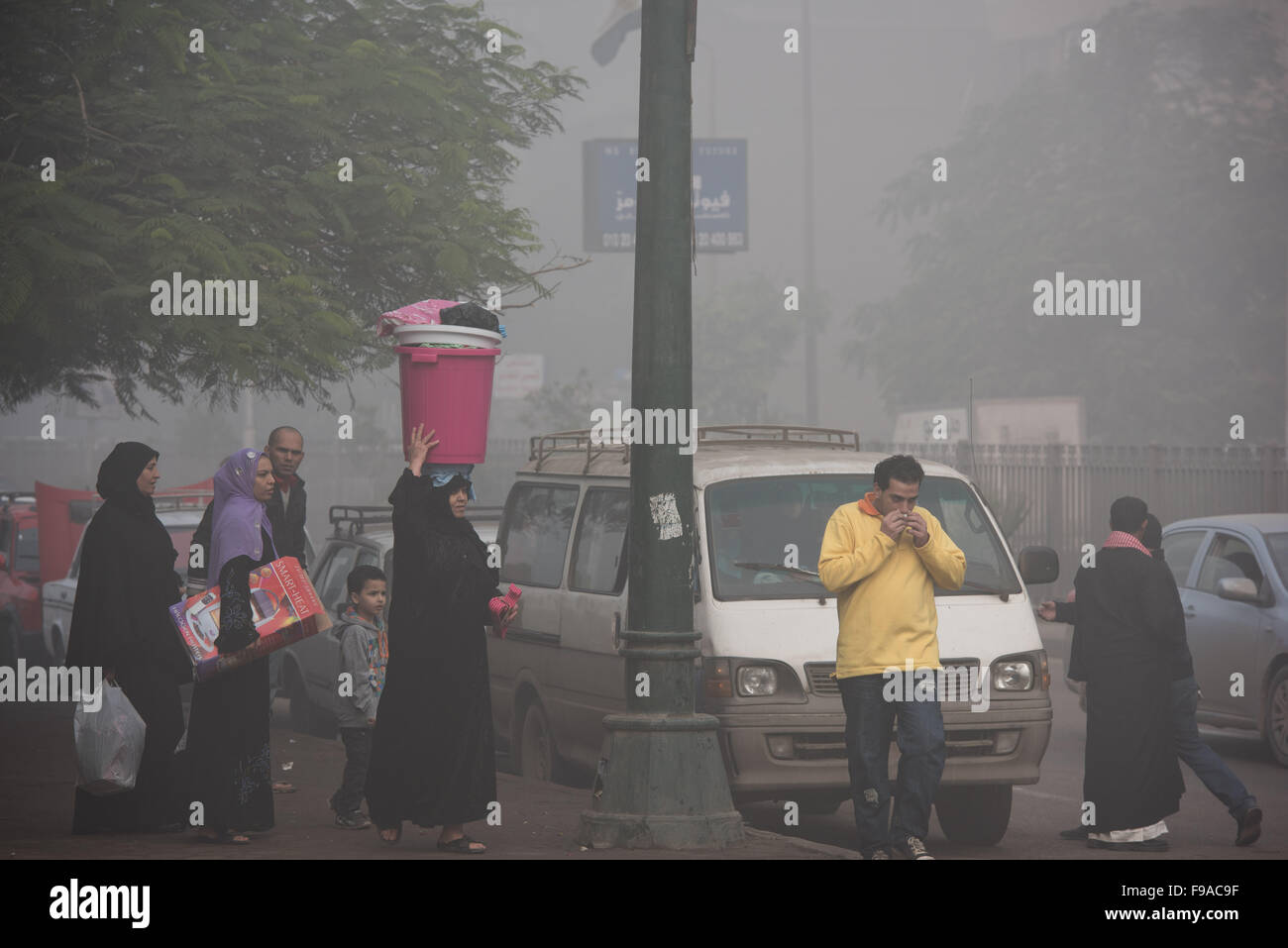 Cairo, Egypt. 15th Dec, 2015. People wait at a bus station in heavy ...