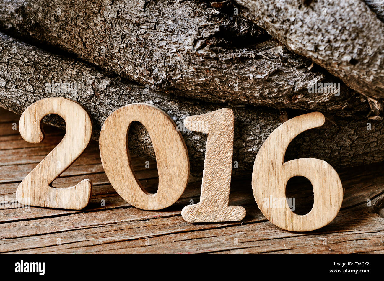 wooden numbers forming the number 2016, as the new year, with a pile of ...