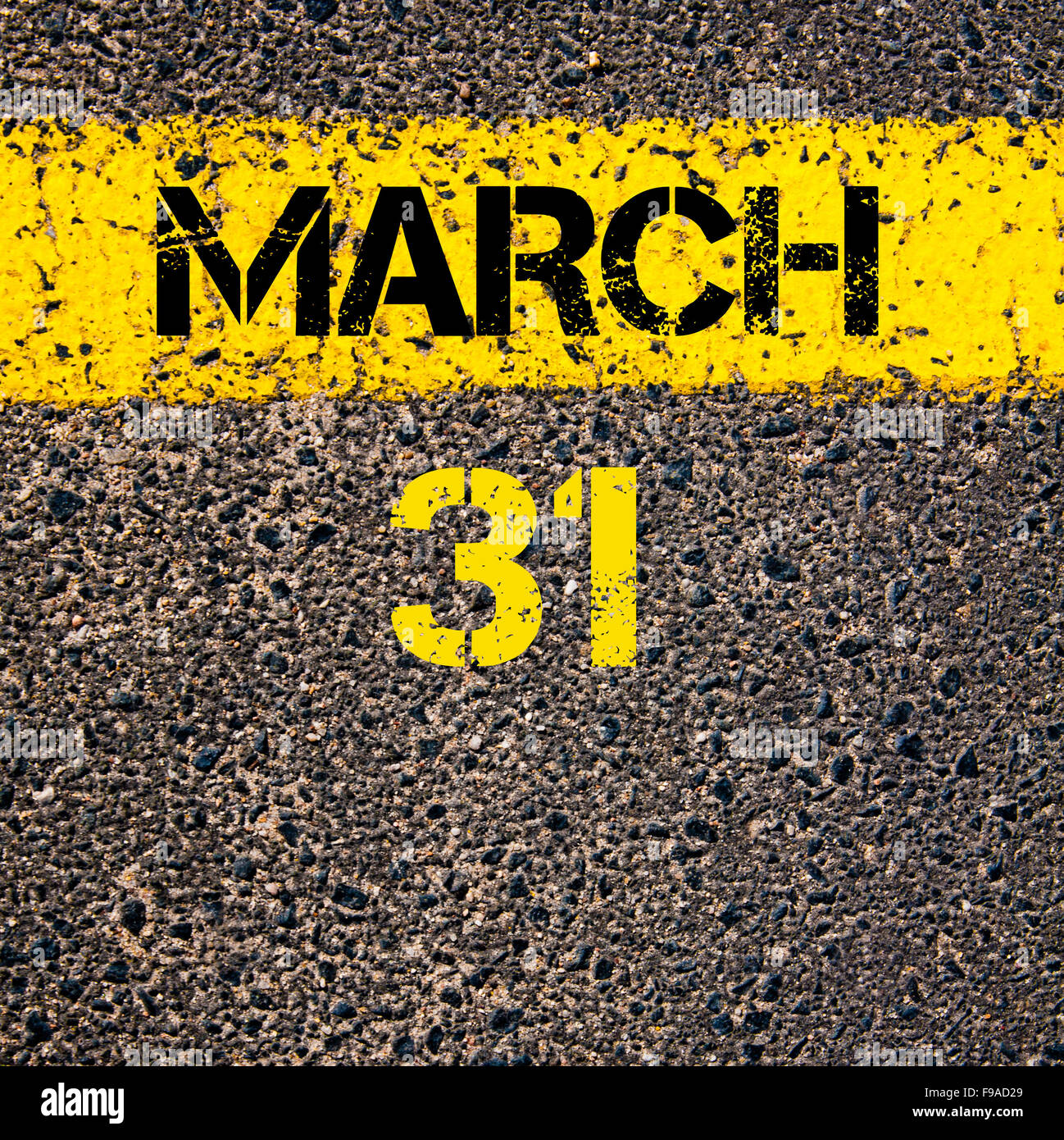 31 March calendar day written over road marking yellow paint line Stock ...