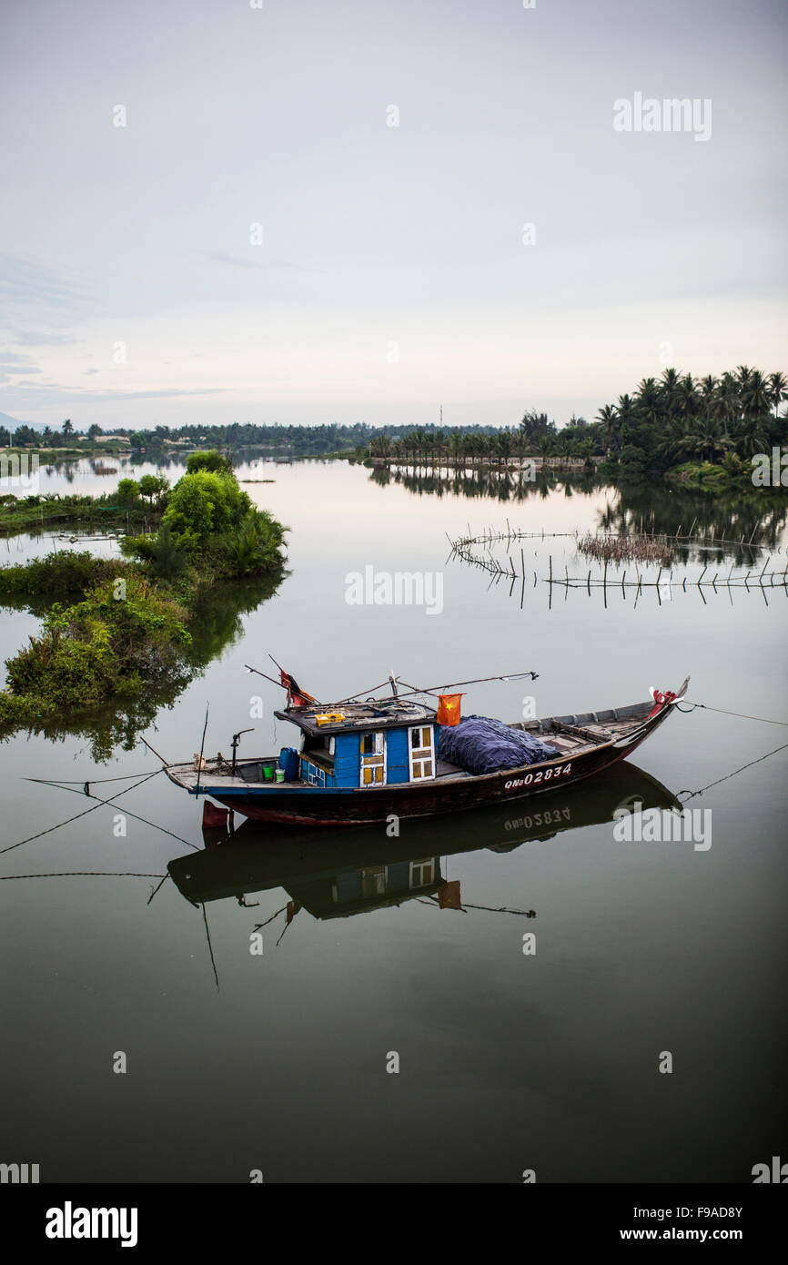 A lone fishing boat is docked in a small inlet near the ancient town of ...