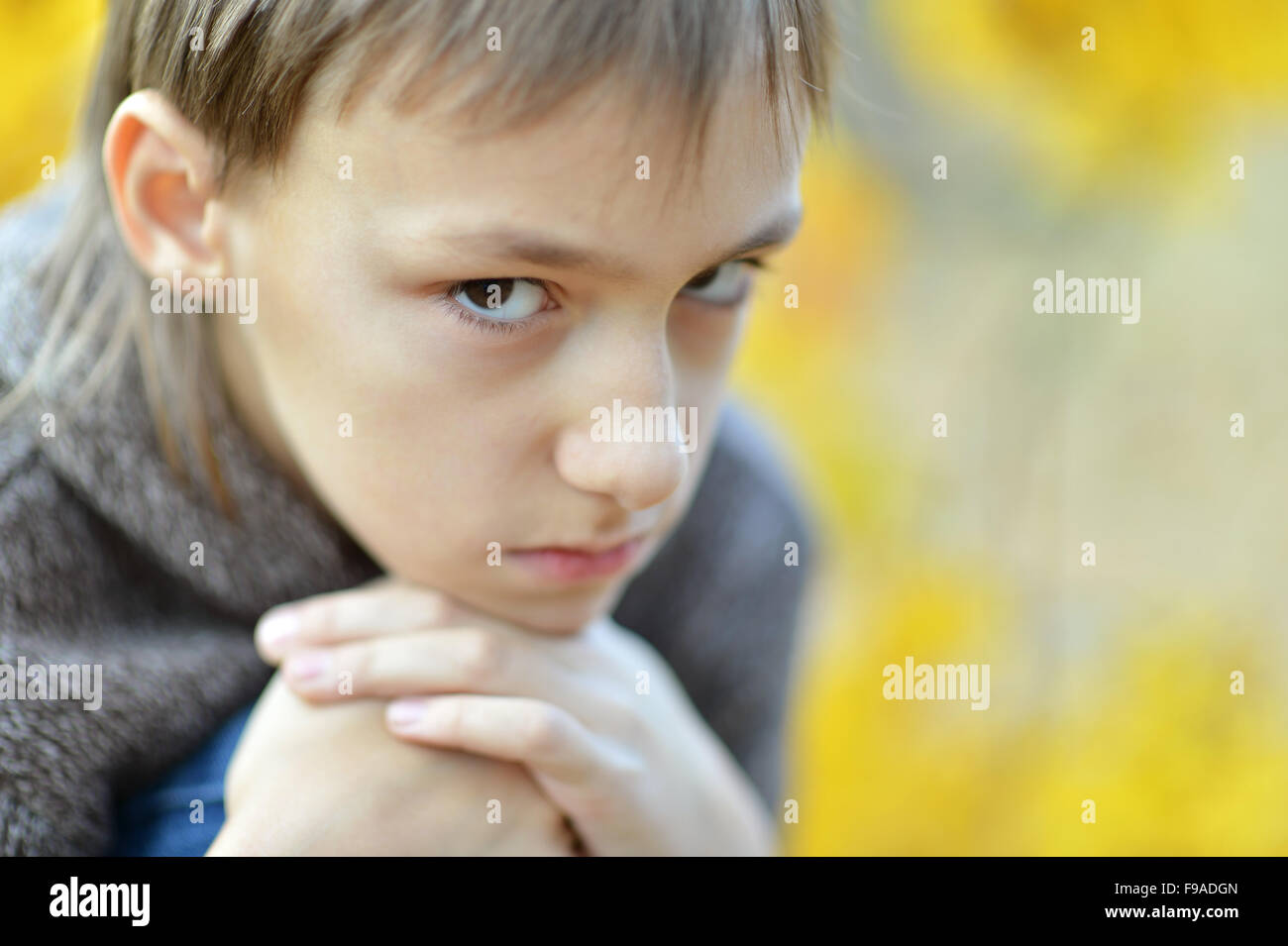 Little sad boy in park Stock Photo - Alamy