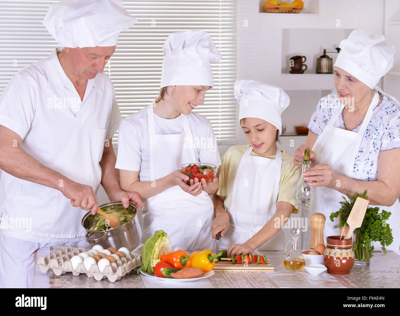 Happy family cooking together Stock Photo - Alamy