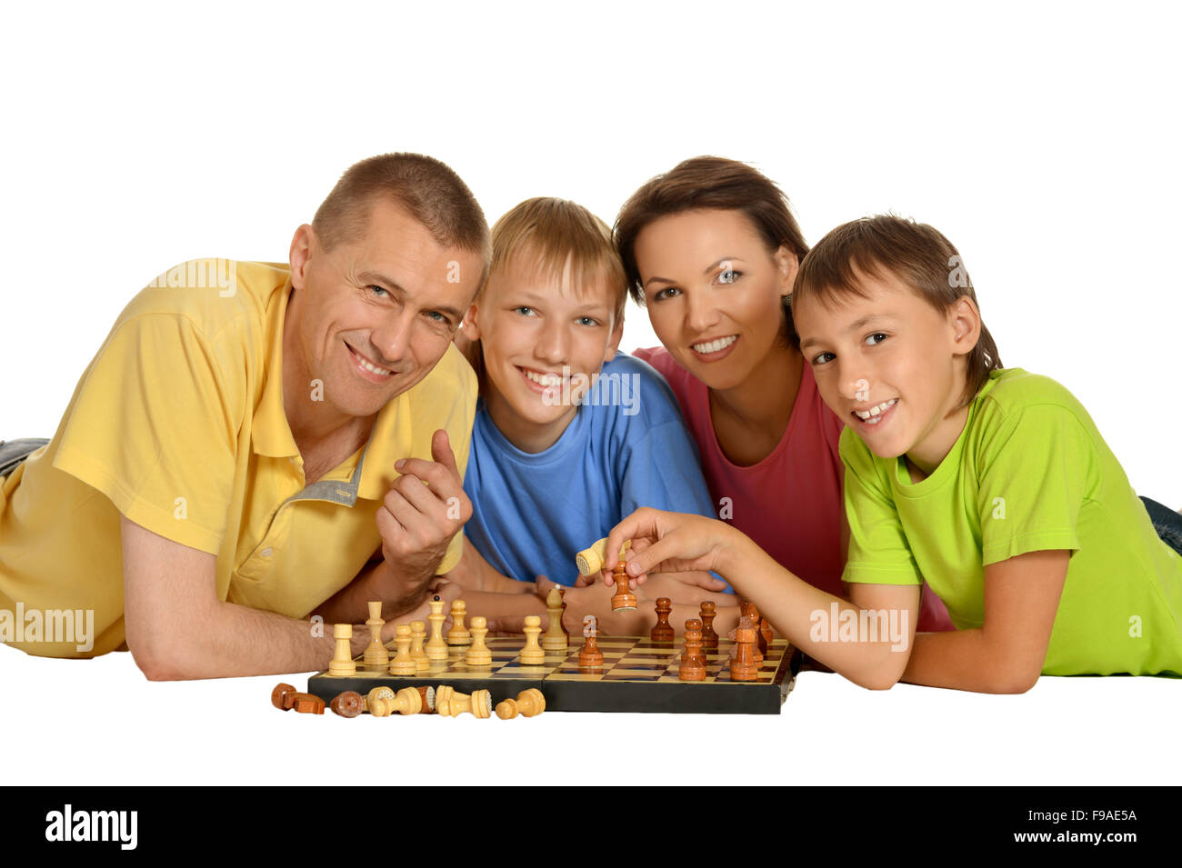 Happy family playing chess Stock Photo - Alamy