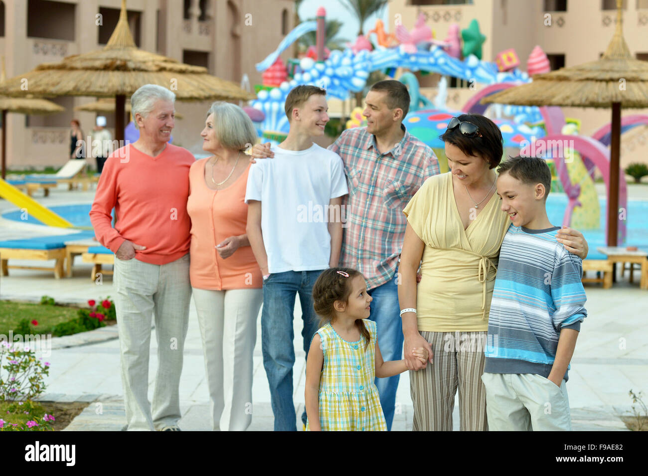 Family relaxing at resort Stock Photo - Alamy