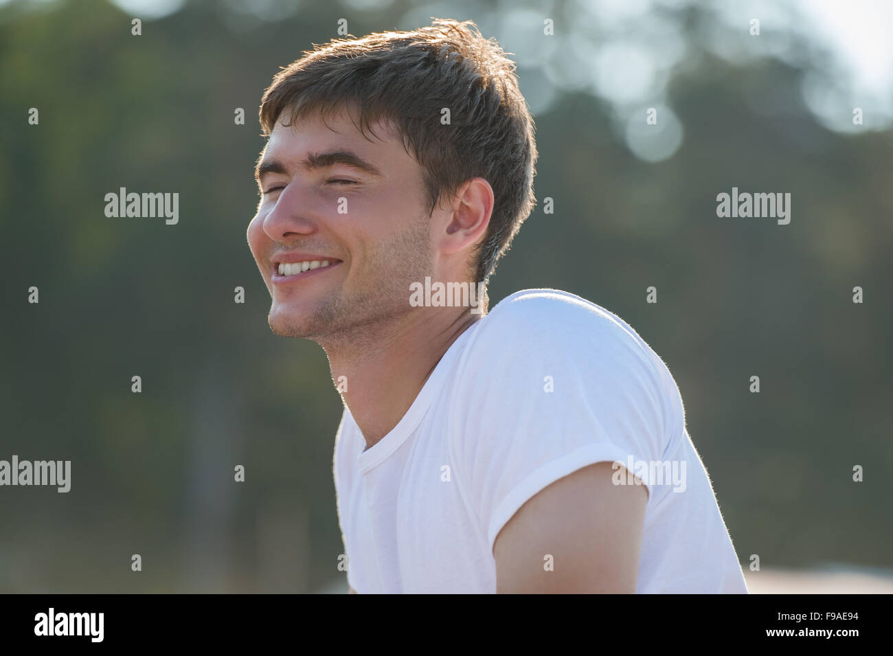 Young man with pure happiness on his face admiring sun Stock Photo - Alamy