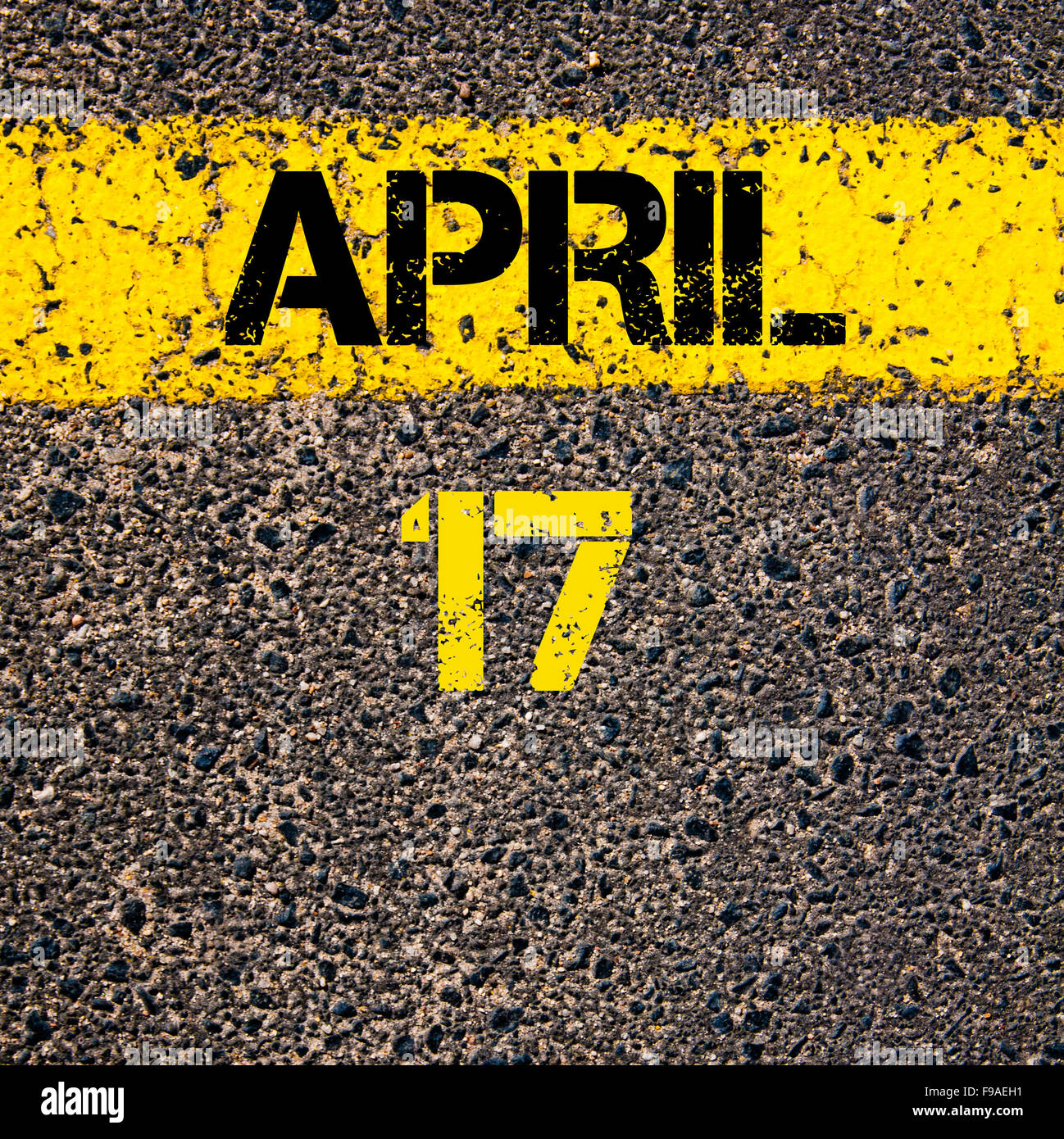 17 April calendar day written over road marking yellow paint line Stock ...