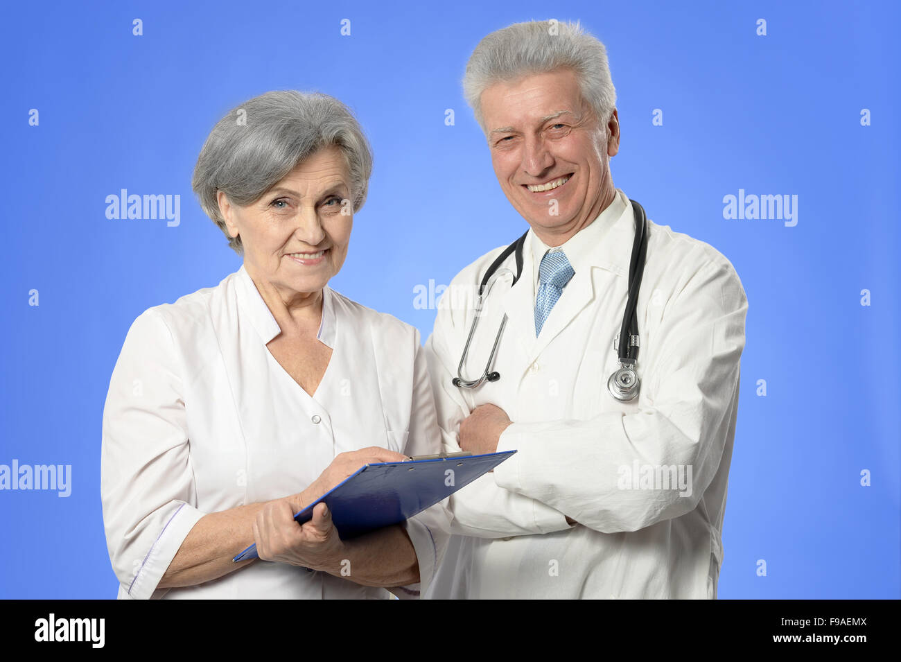 Two senior doctors on blue Stock Photo - Alamy