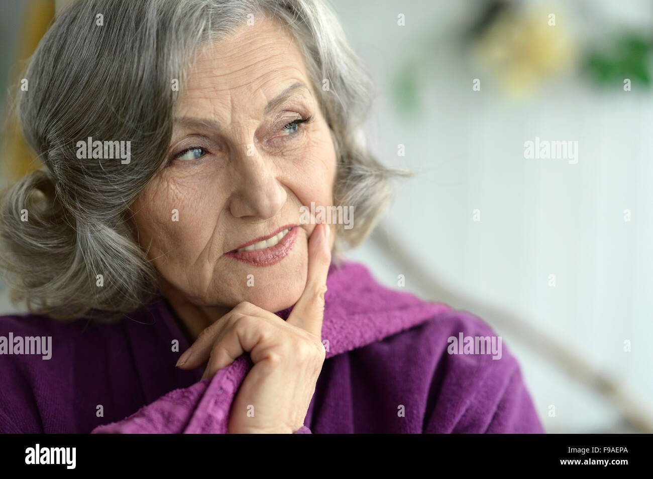 Portrait of thinking elderly woman Stock Photo - Alamy