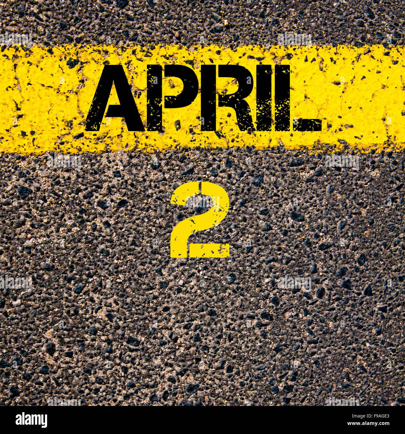2 April calendar day written over road marking yellow paint line Stock ...
