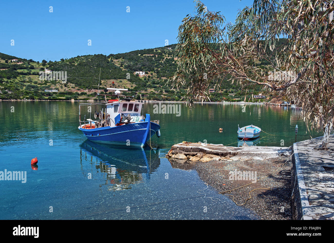 Traditional caique mooring at Agios Nikolaos haven located on the coast ...