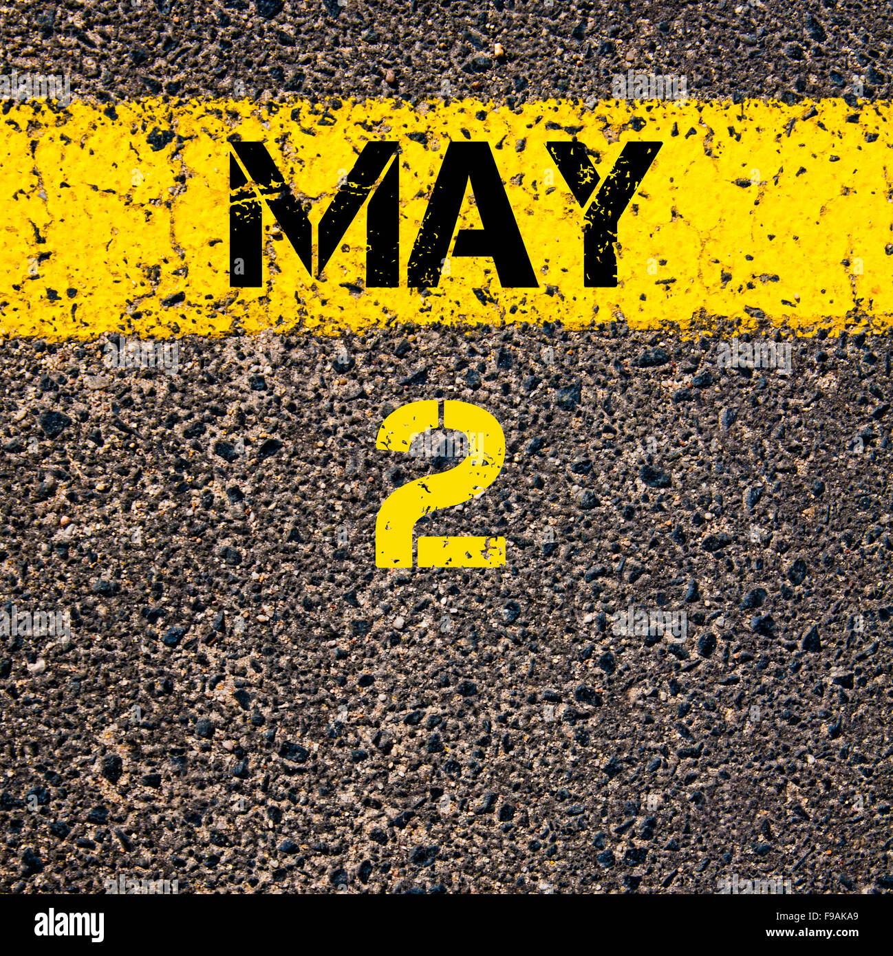 2 May calendar day written over road marking yellow paint line Stock ...