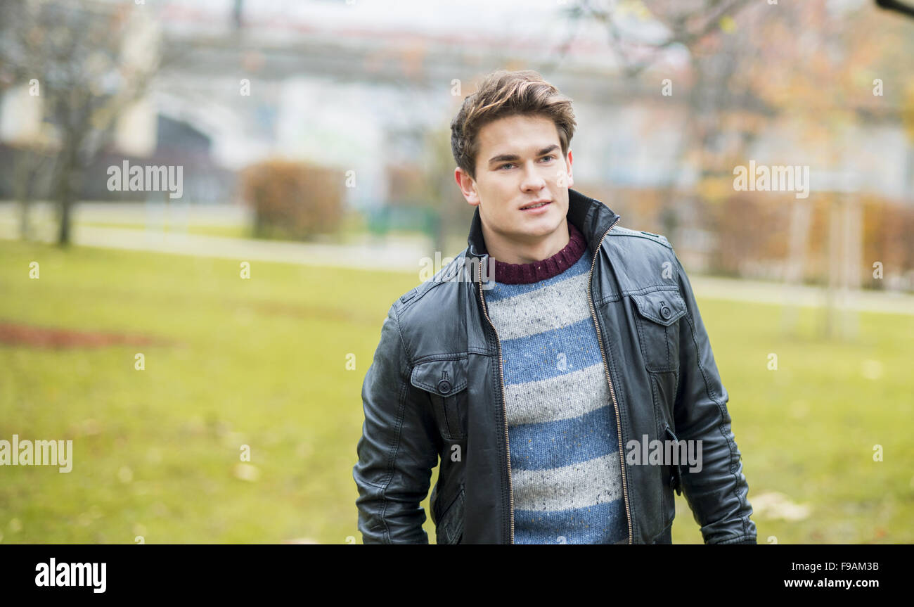 Young man is taking rest in the city park Stock Photo - Alamy