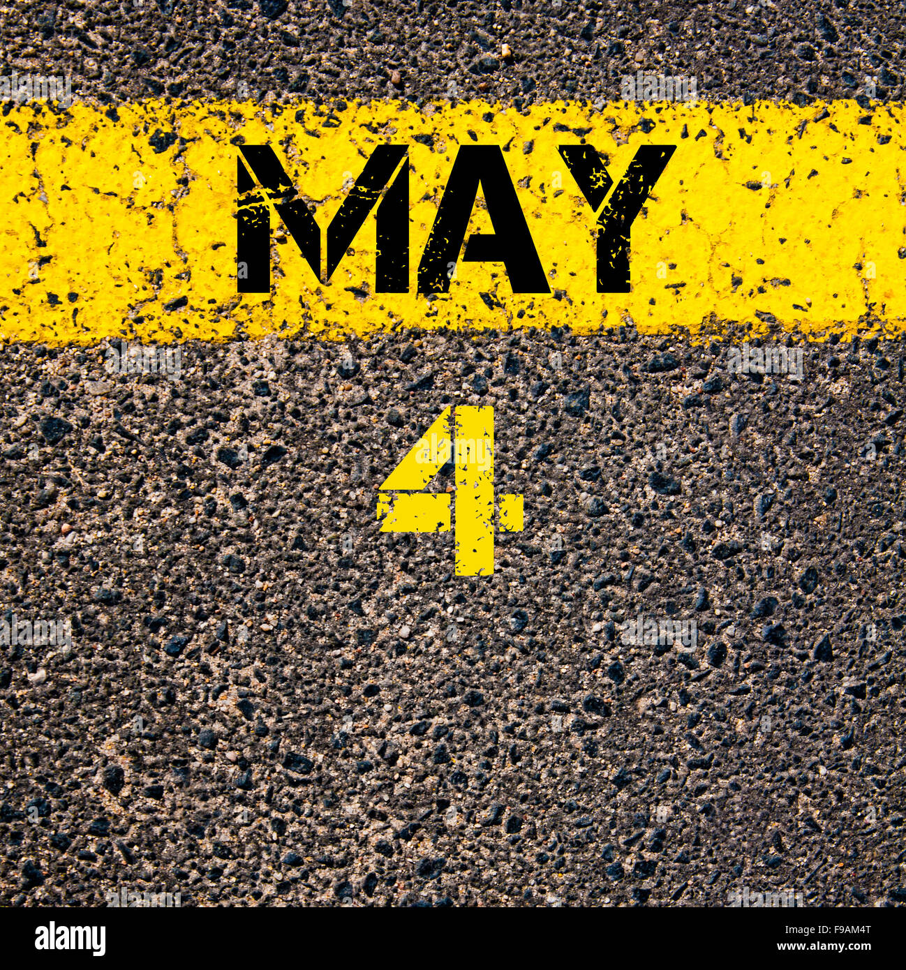 4 May calendar day written over road marking yellow paint line Stock ...