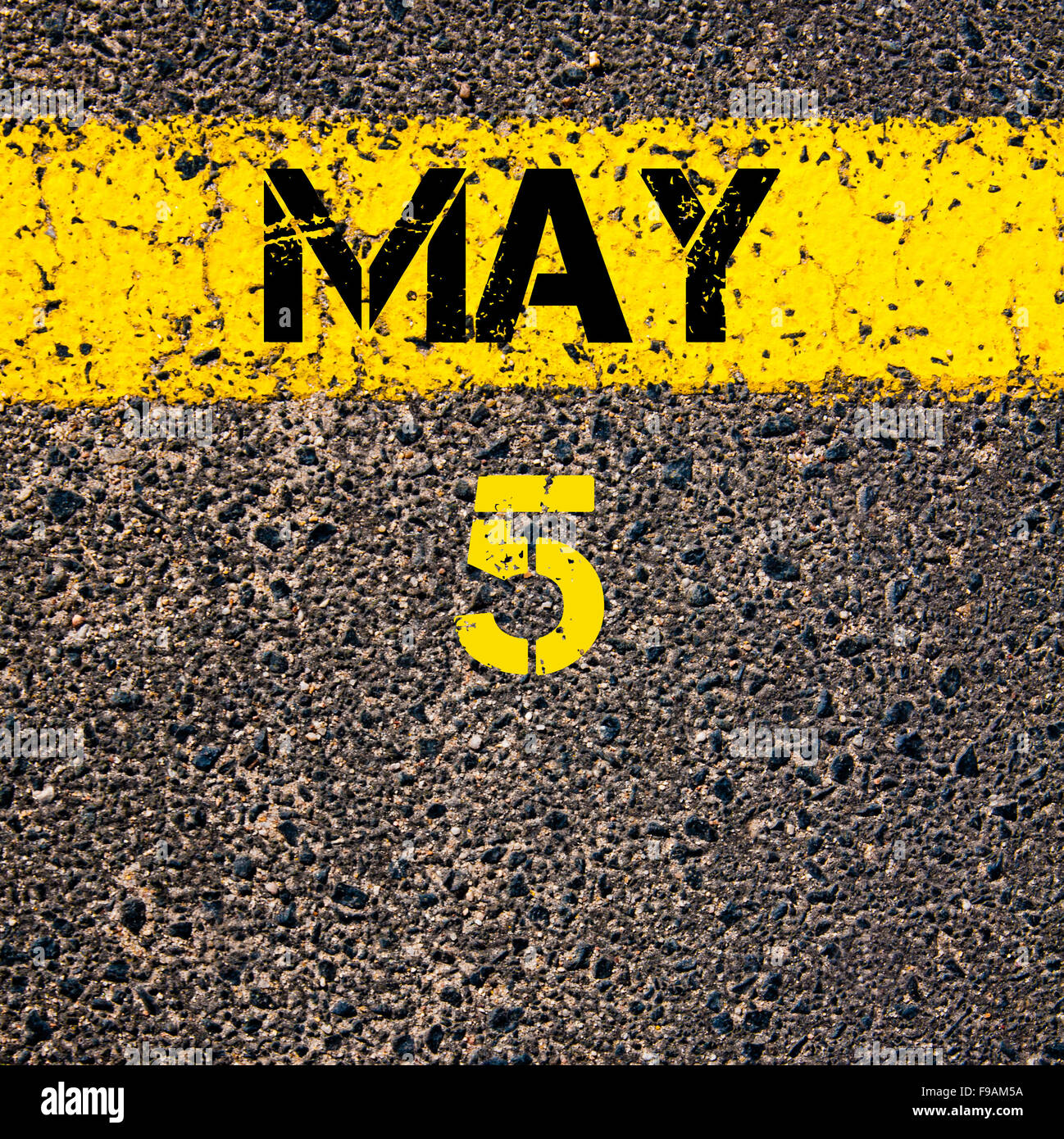 5 May calendar day written over road marking yellow paint line Stock ...