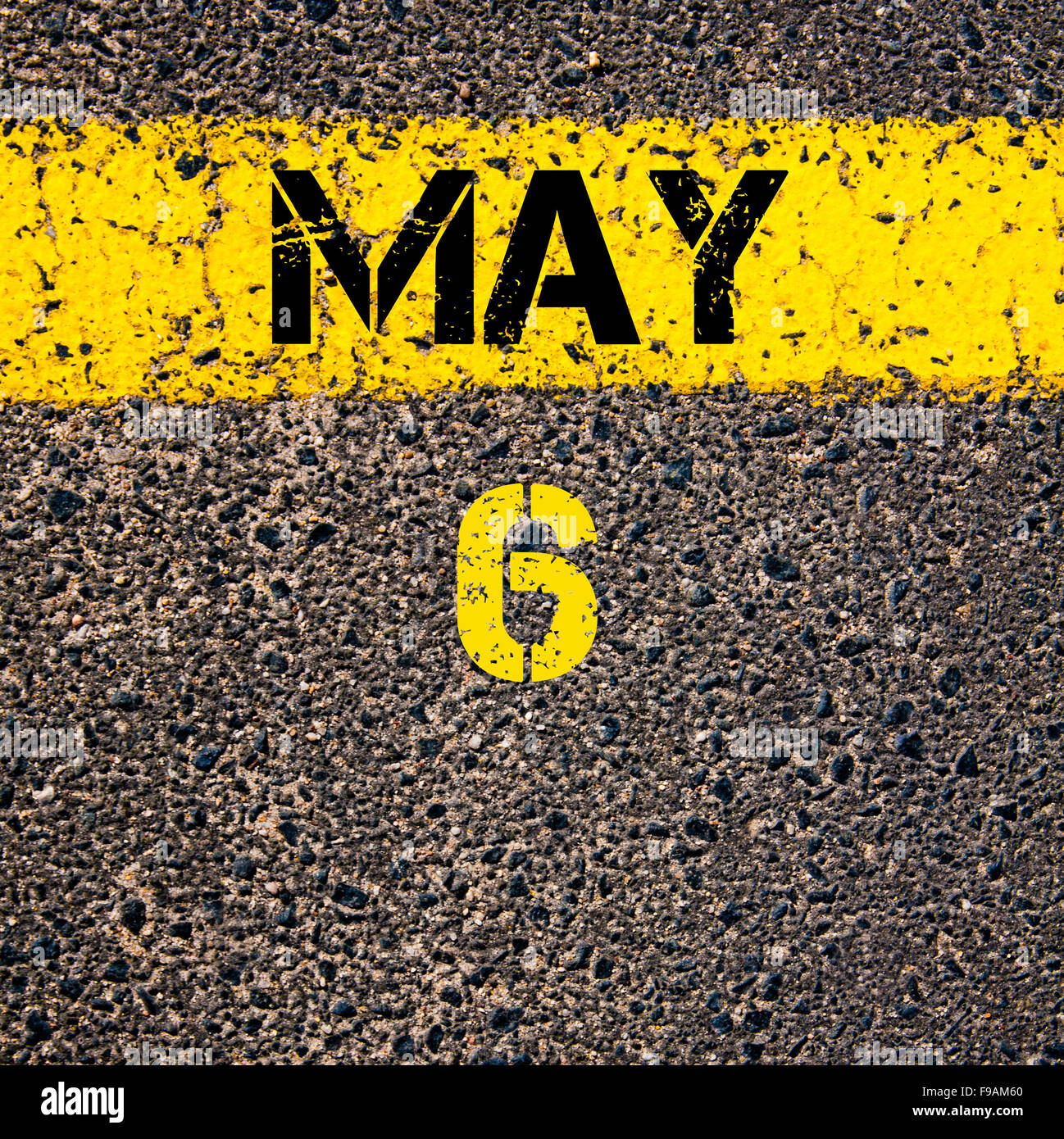 6 May calendar day written over road marking yellow paint line Stock ...