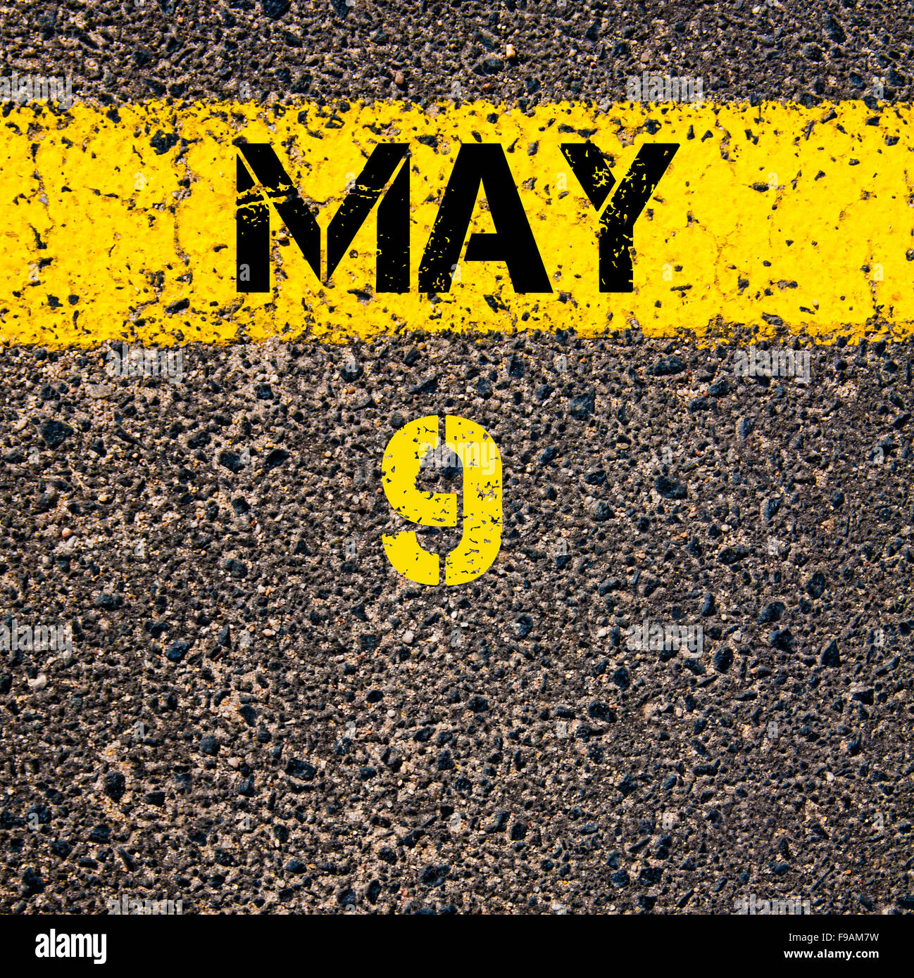 9 May calendar day written over road marking yellow paint line Stock ...