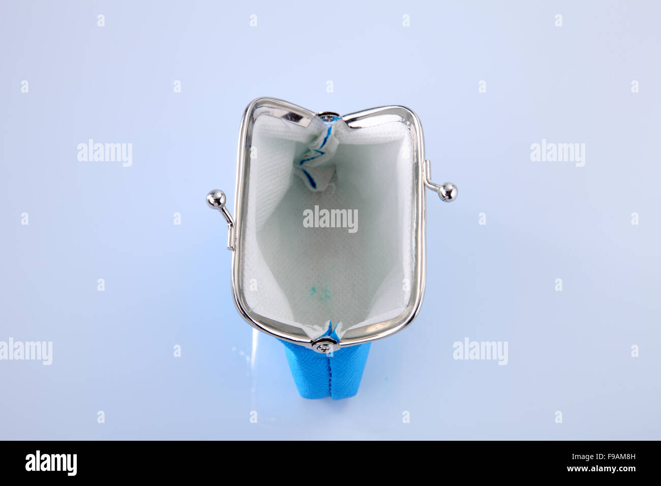 empty blue purse open on the white background Stock Photo - Alamy