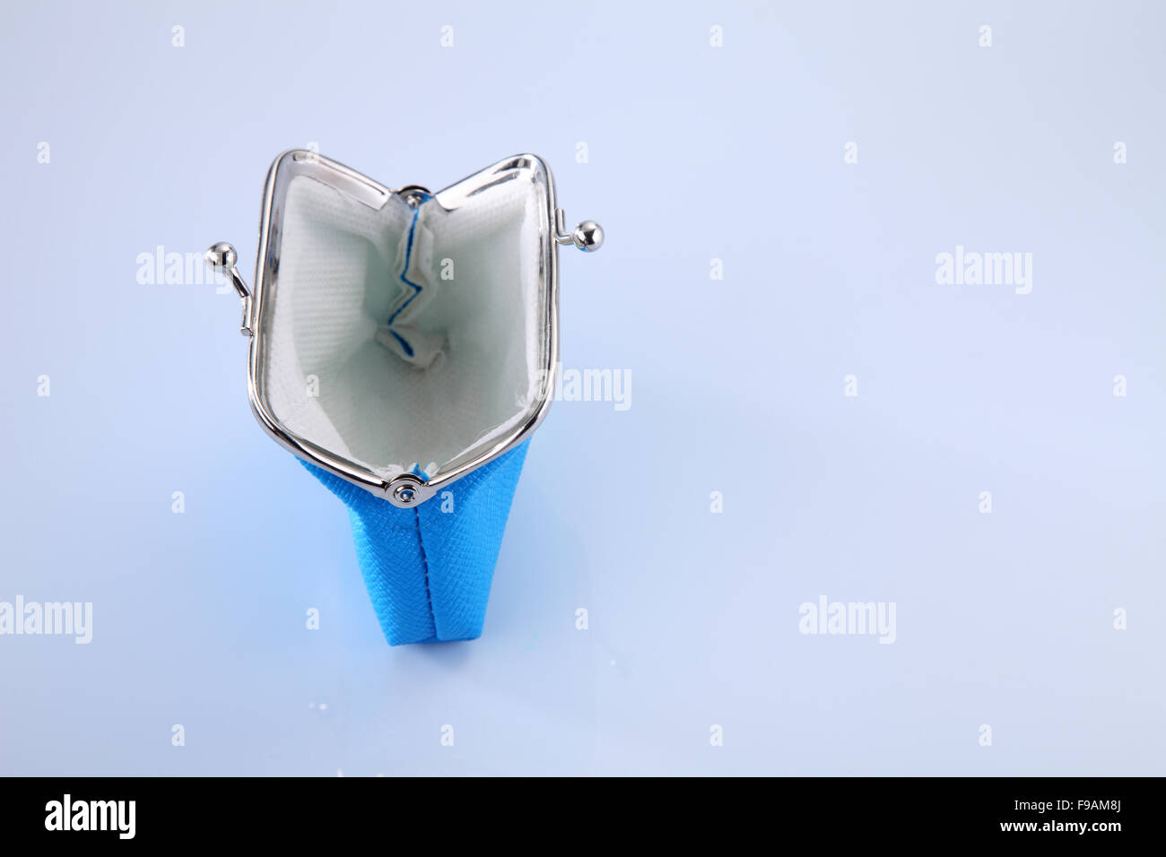 empty blue purse open on the white background Stock Photo - Alamy