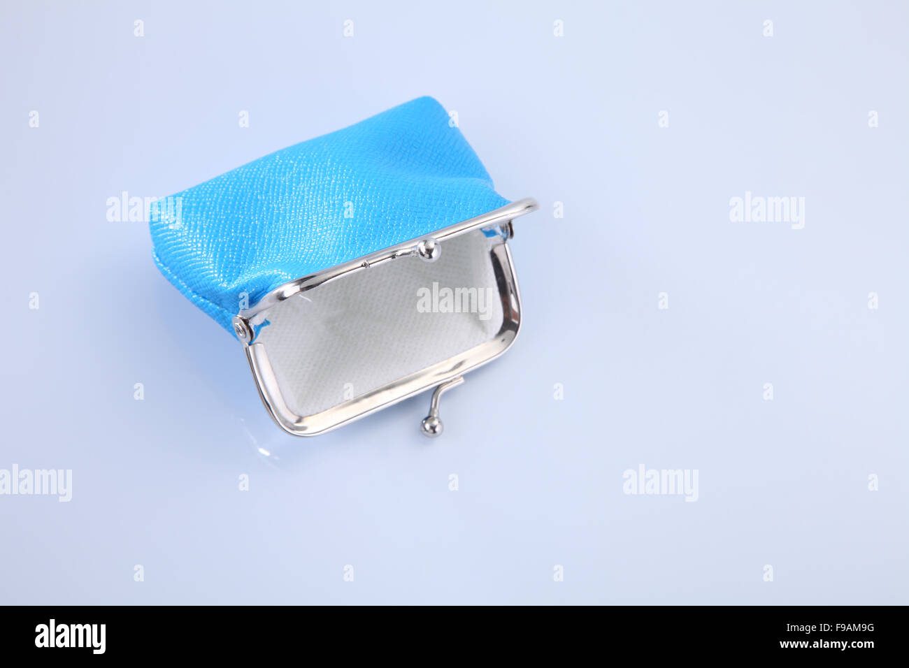 empty blue purse open on the white background Stock Photo - Alamy