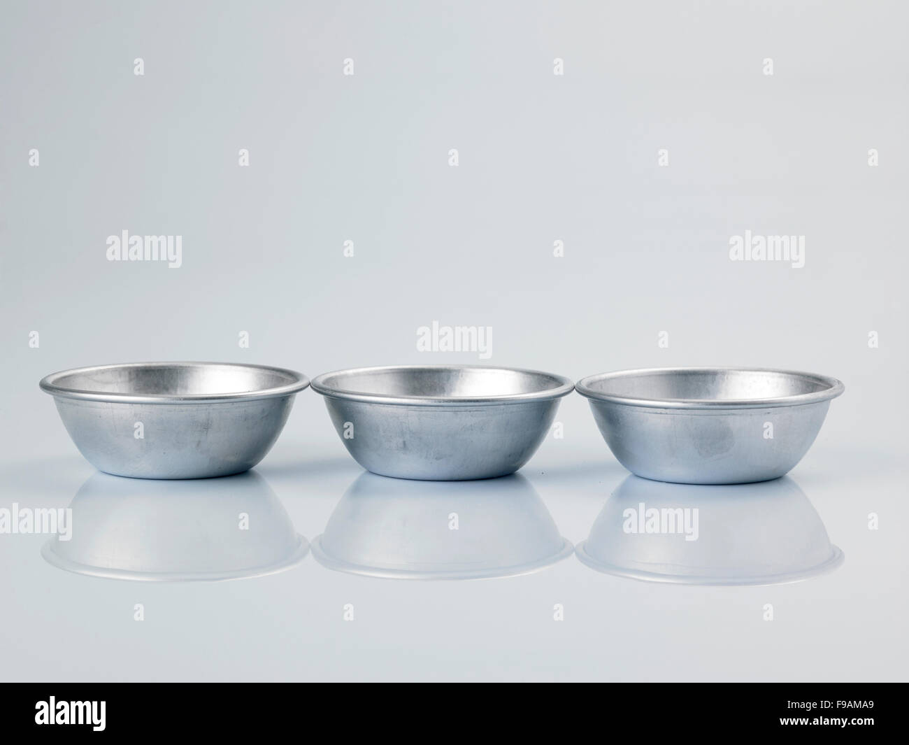 three aluminium small saucer in the white background Stock Photo - Alamy