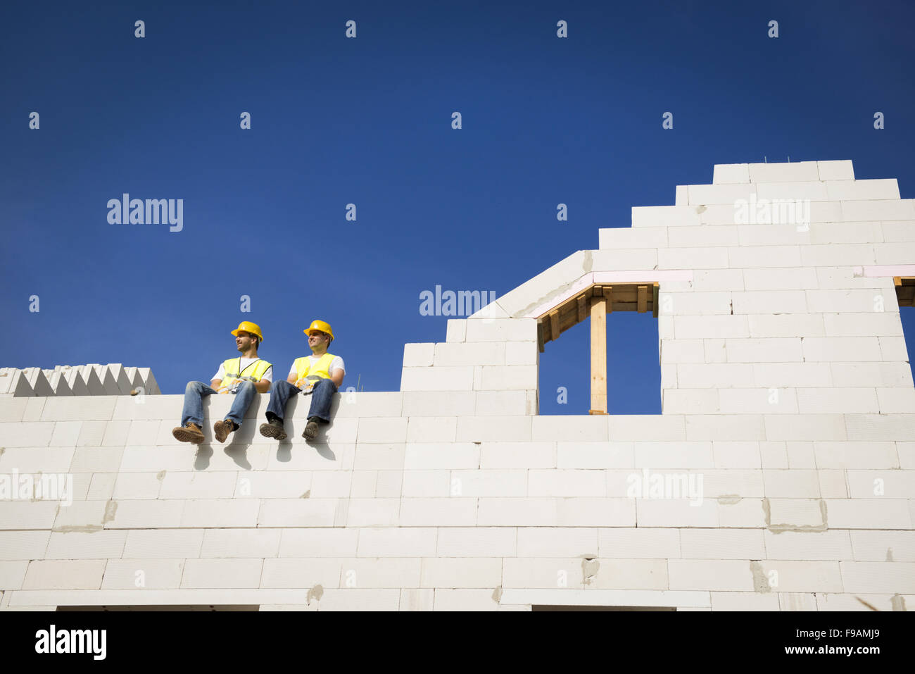 Construction Contractors building a big new home Stock Photo - Alamy