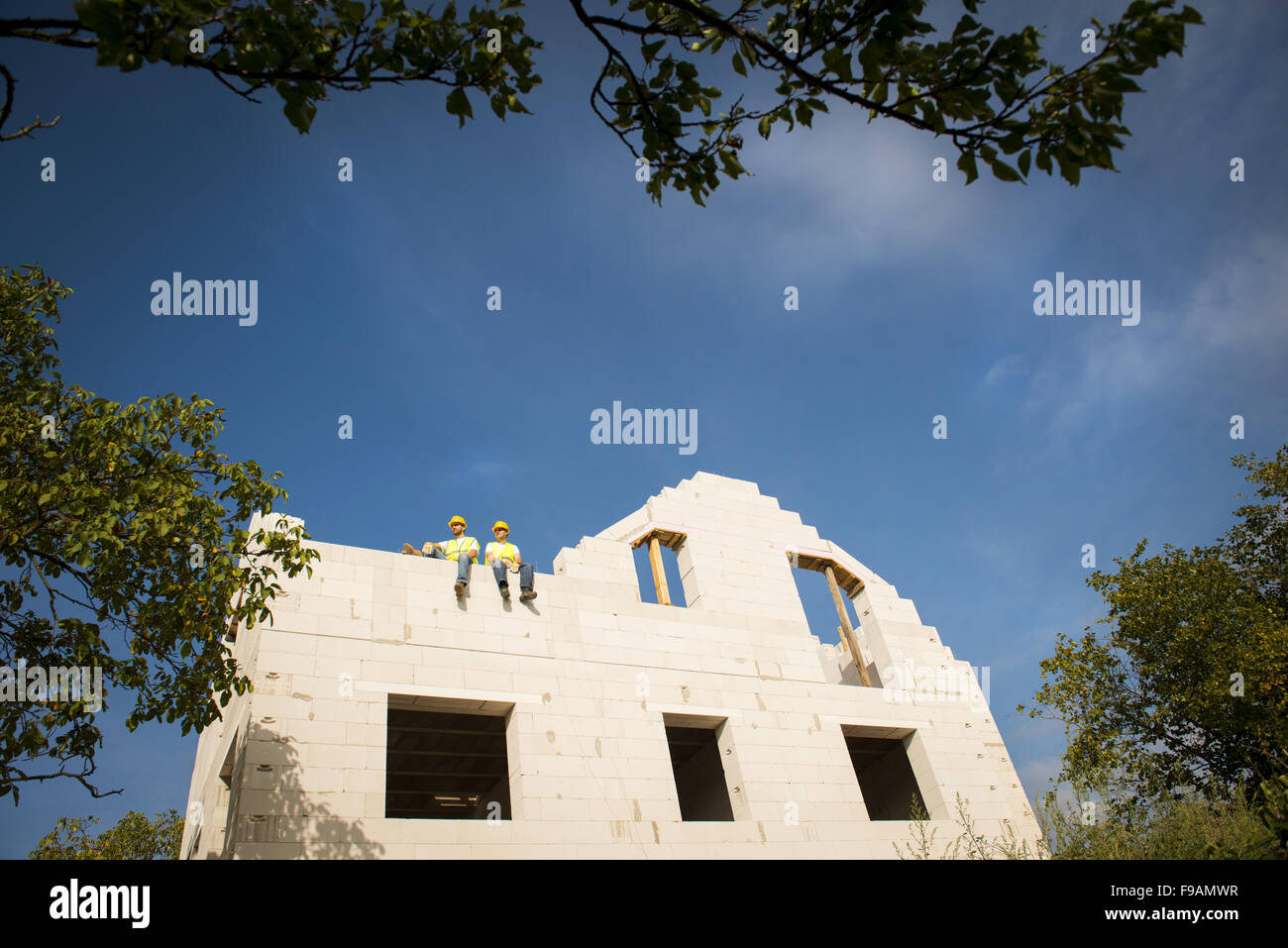 Construction Contractors building a big new home Stock Photo - Alamy