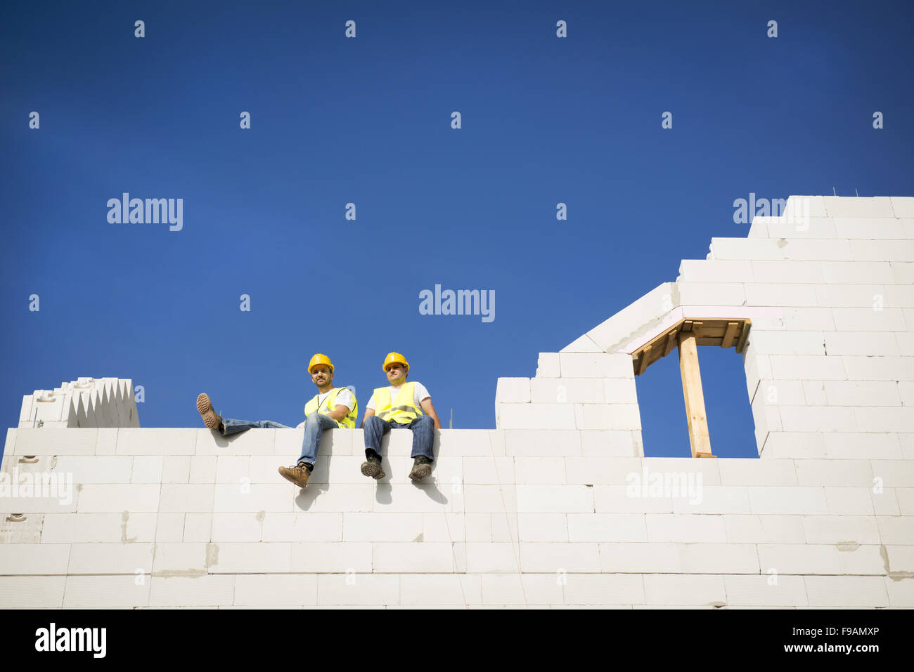 Construction Contractors building a big new home Stock Photo - Alamy