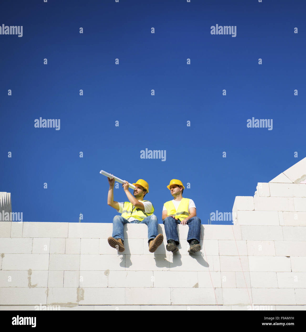 Construction Contractors building a big new home Stock Photo - Alamy