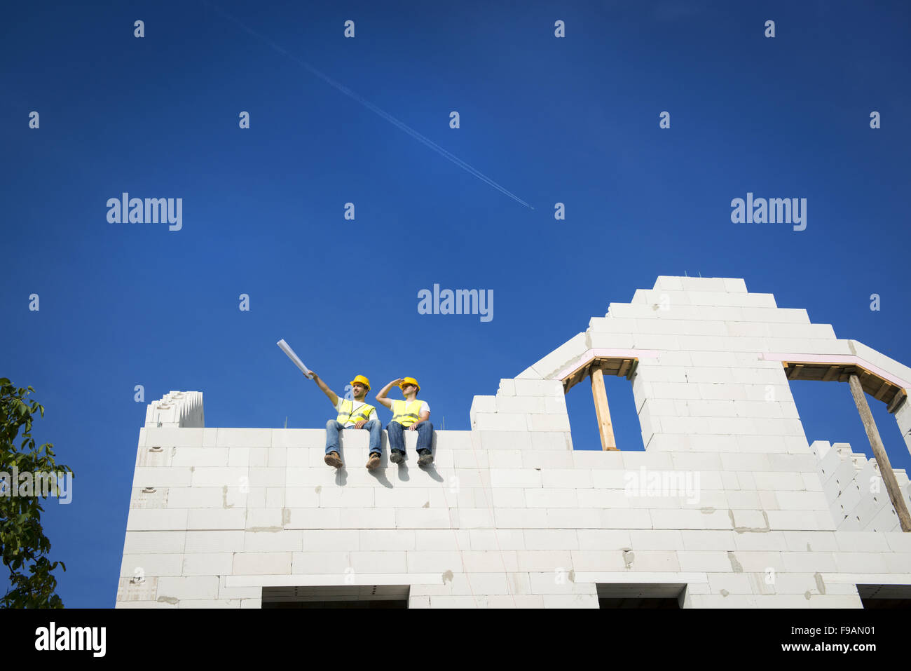 Construction Contractors building a big new home Stock Photo - Alamy