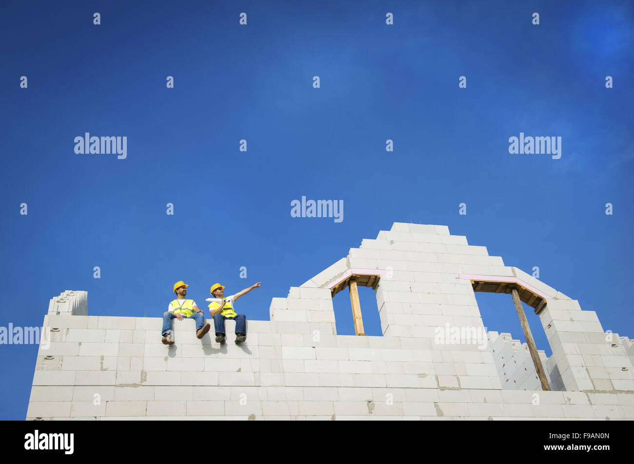 Construction Contractors building a big new home Stock Photo - Alamy