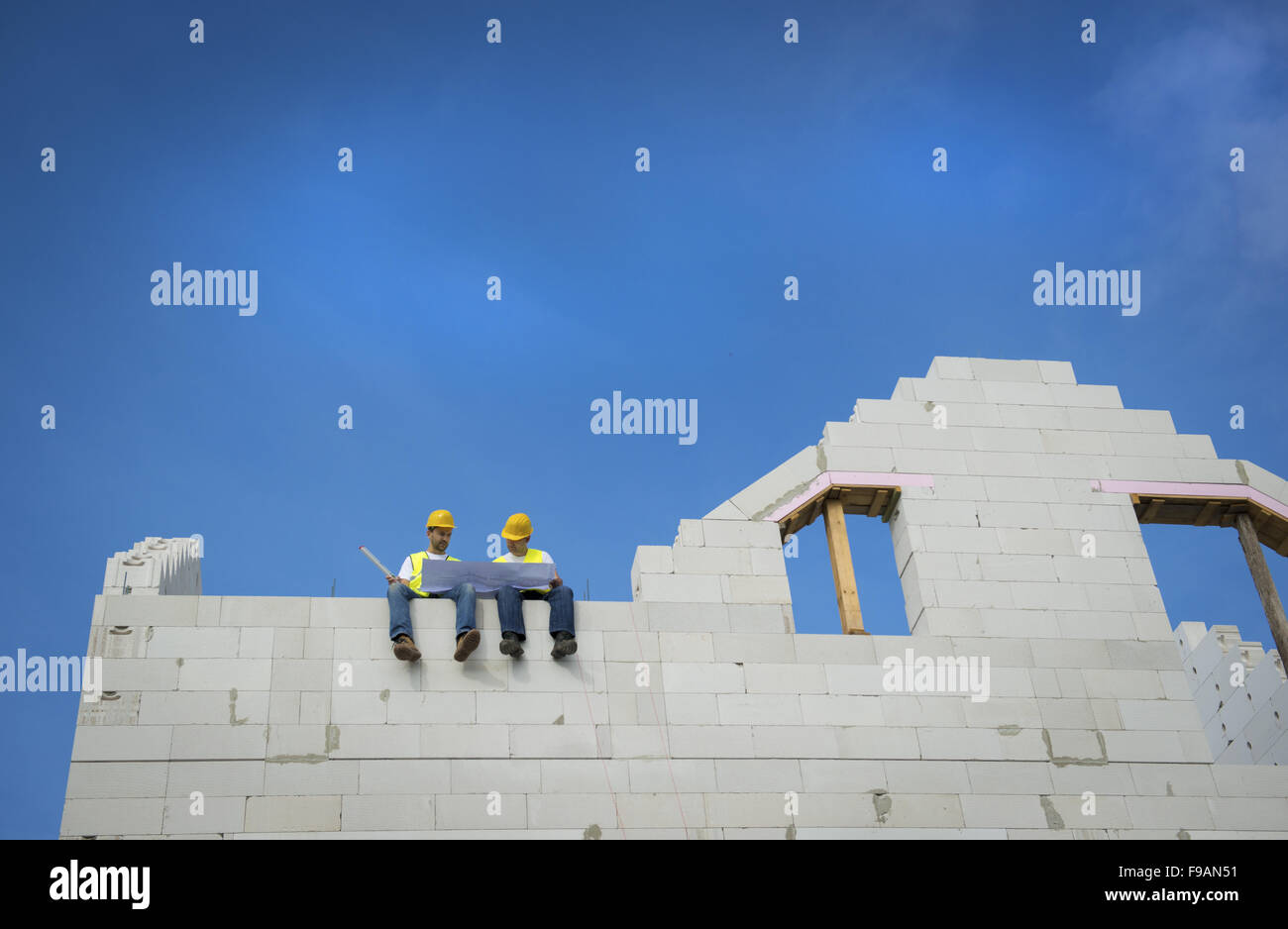 Construction Contractors building a big new home Stock Photo - Alamy