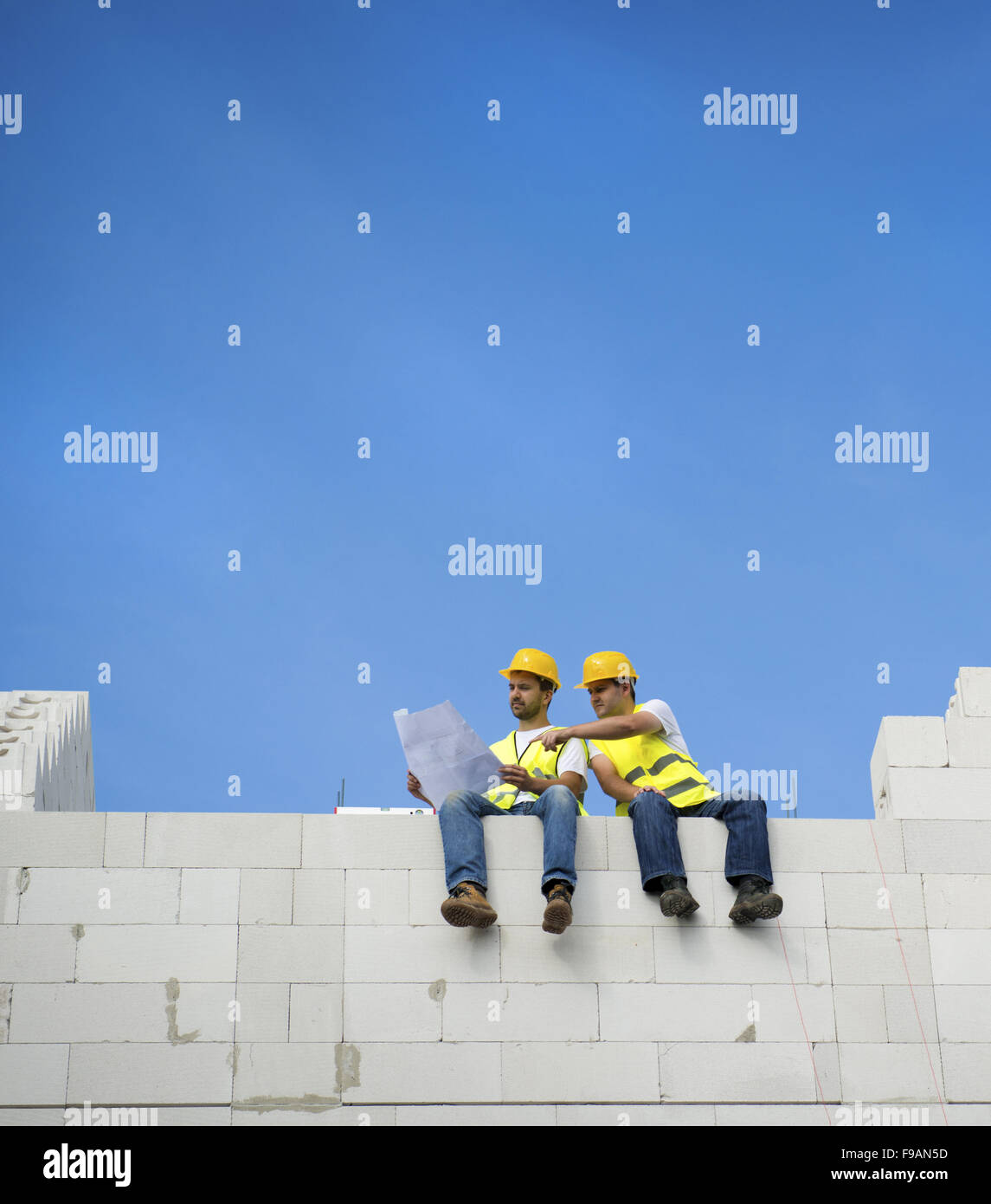 Construction Contractors building a big new home Stock Photo - Alamy