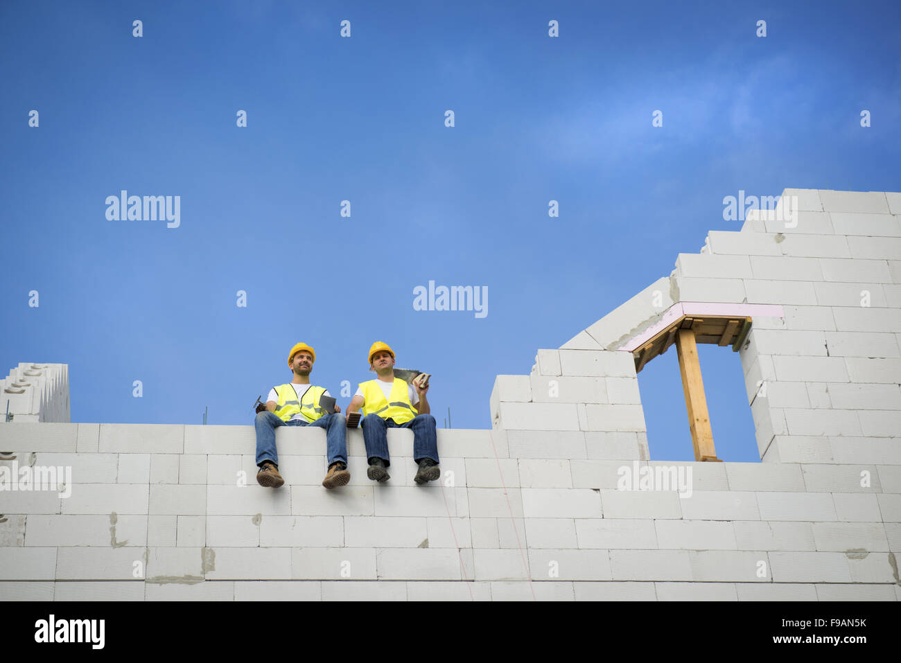 Construction Contractors building a big new home Stock Photo - Alamy