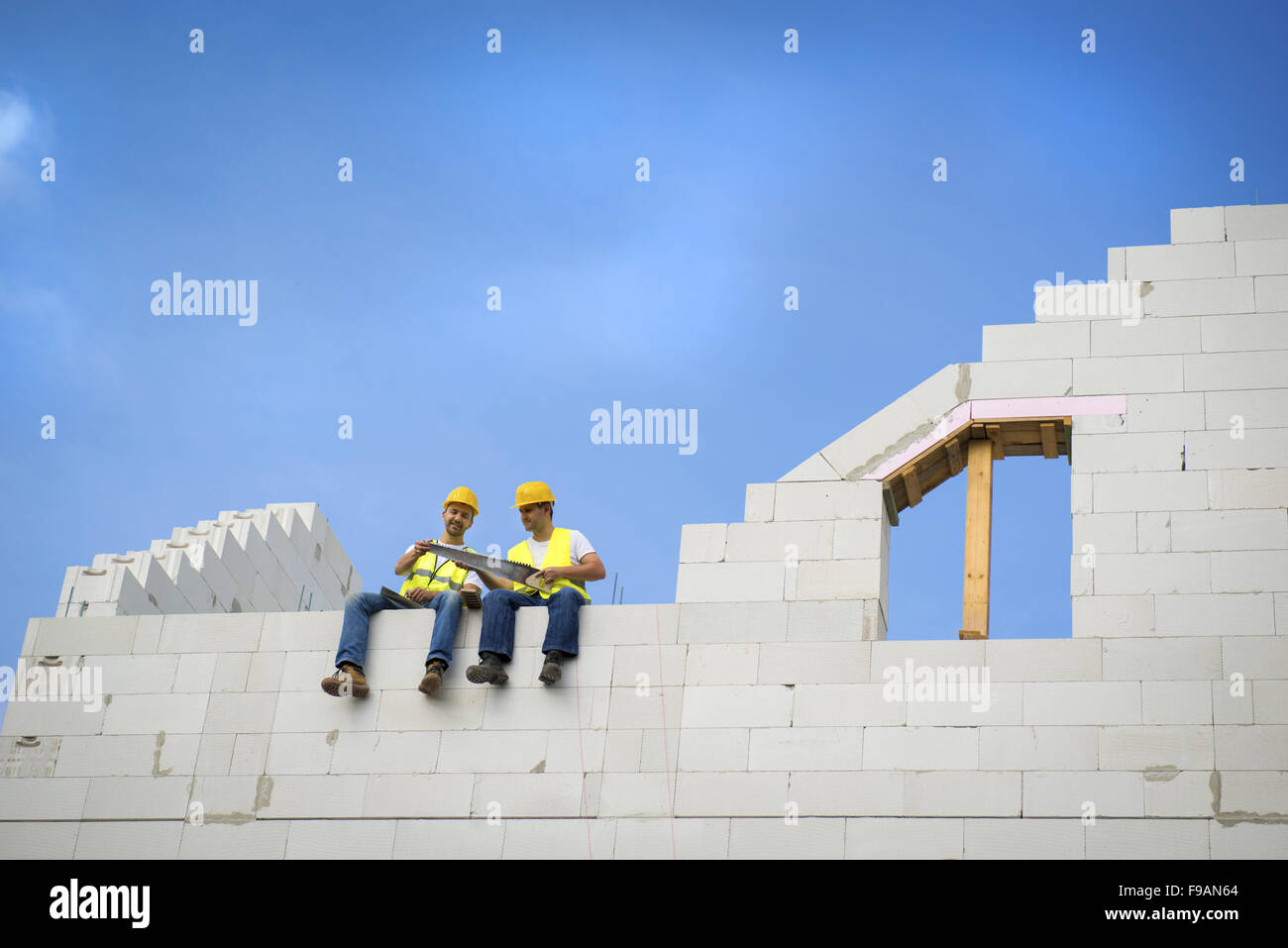 Construction Contractors building a big new home Stock Photo - Alamy